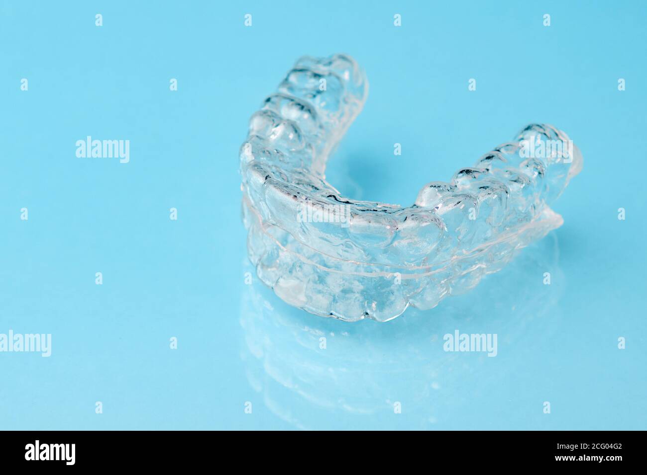 Close up invisible aligners on the blue background with copy space ...