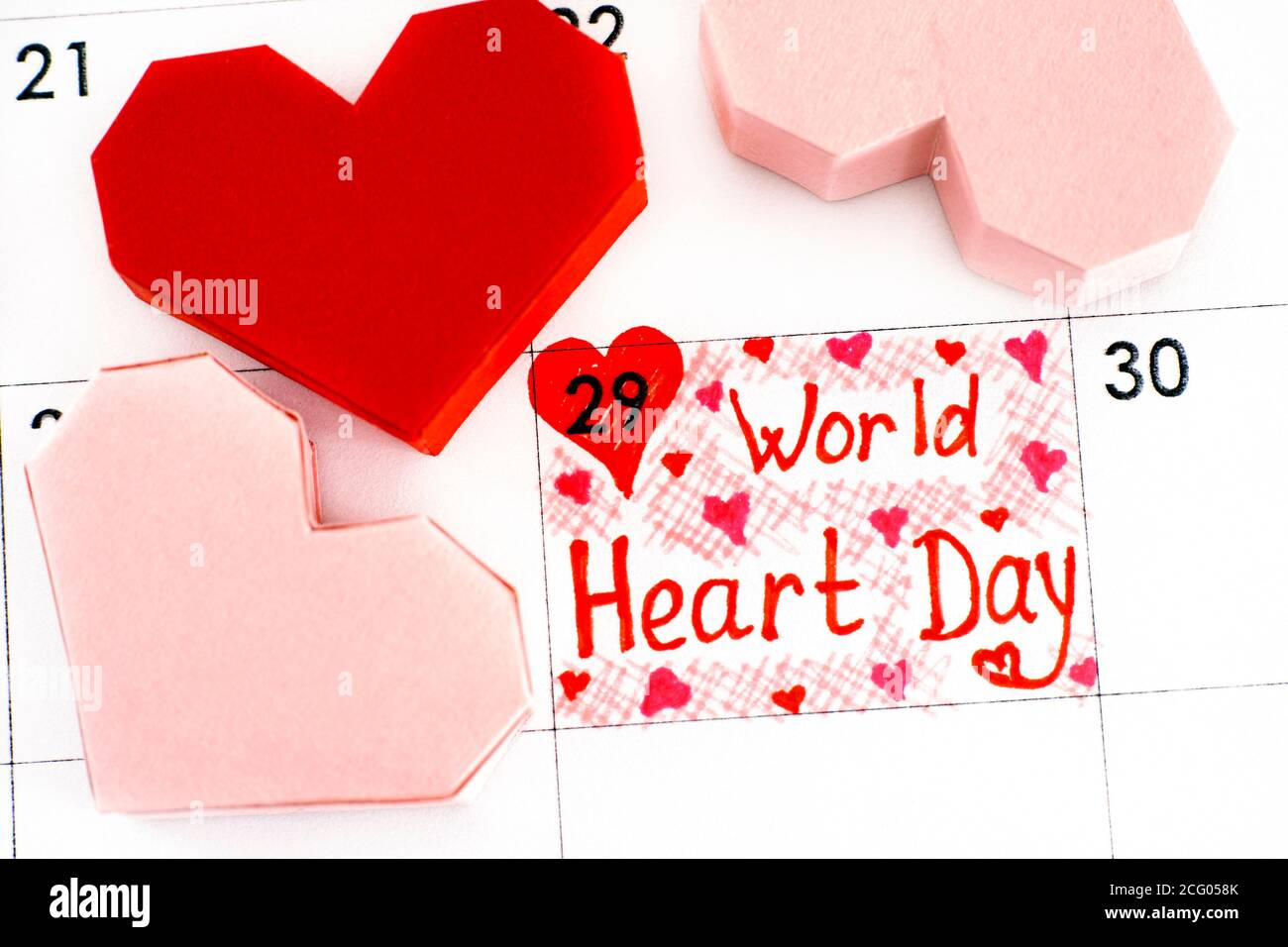 Reminder World Heart Day in calendar with red and pink origami hearts ...