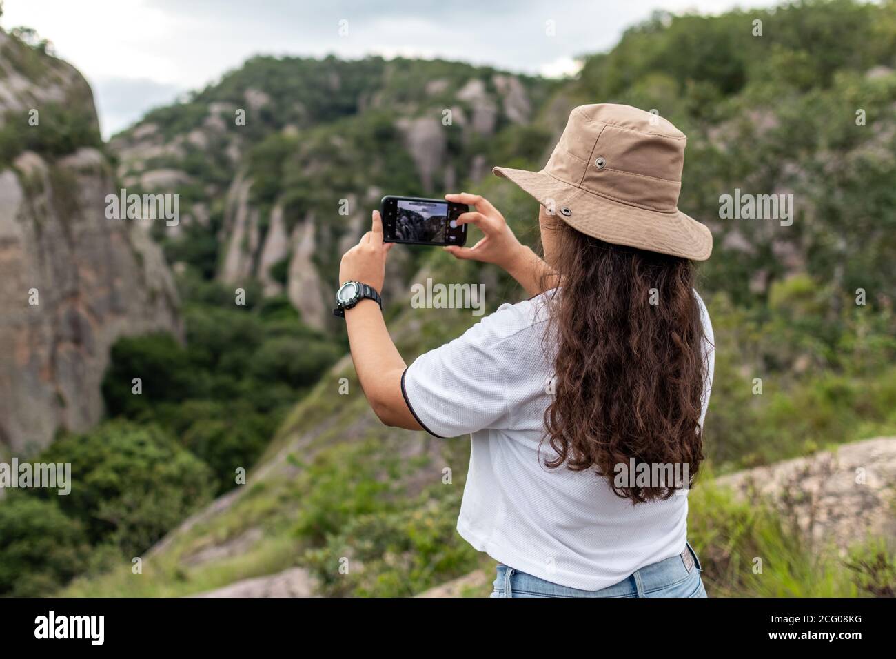 Young woman taking pictures in remote landscape hi-res stock ...
