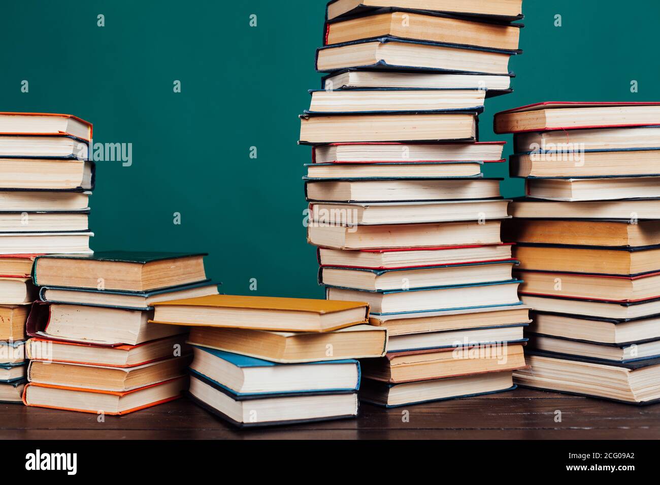many stacks of educational books to study in the university library as ...