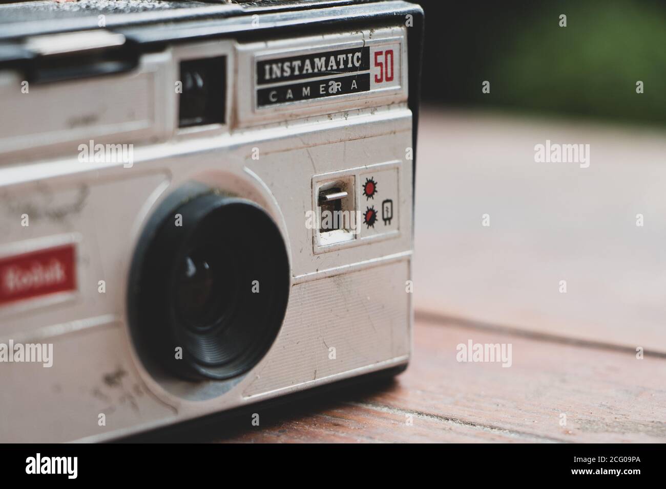 Old and worn photo camera from the 60s on rustic wooden table Stock ...