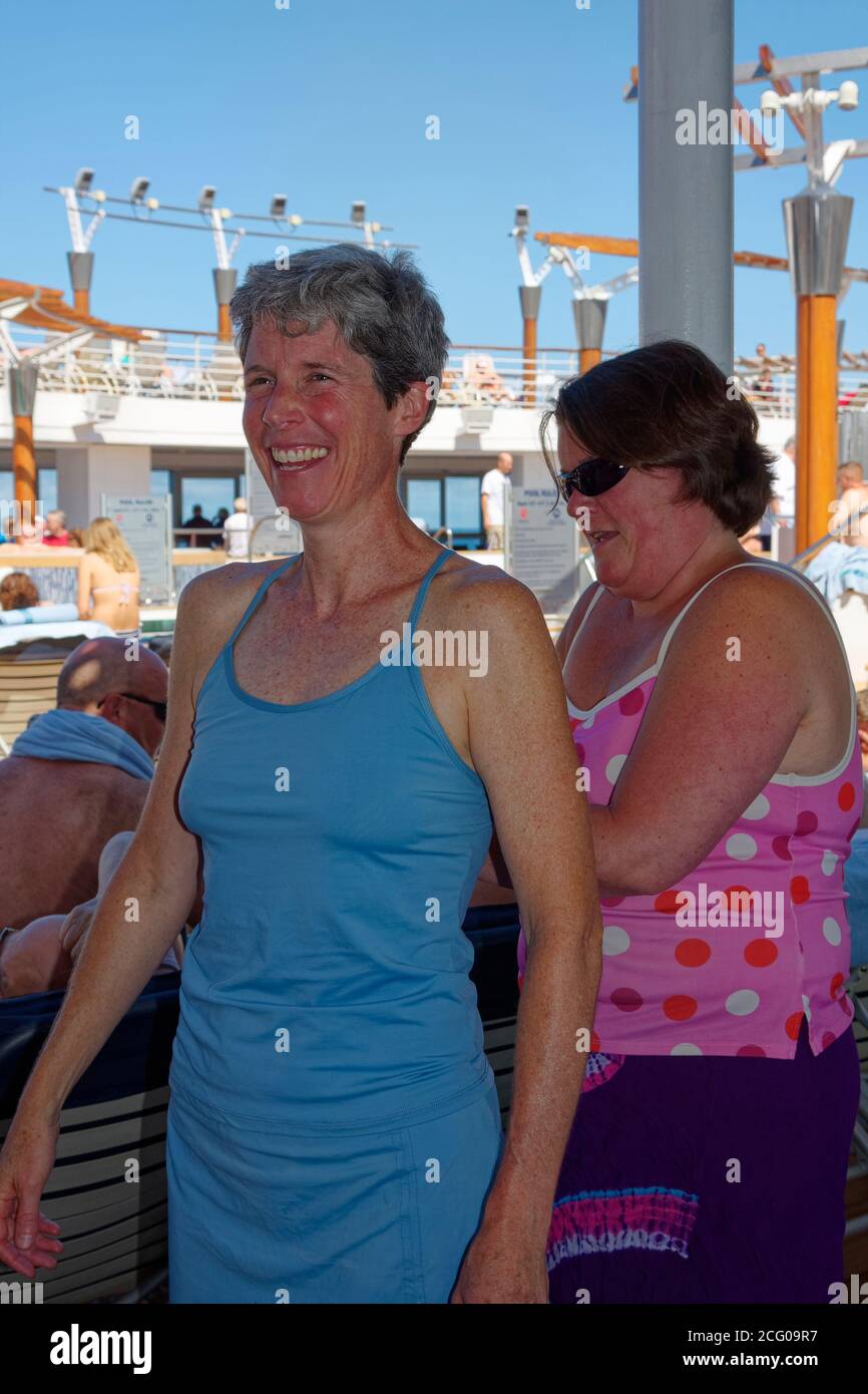 Woman Applying Sunscreen To Friend Health Precaution Smiling Happy