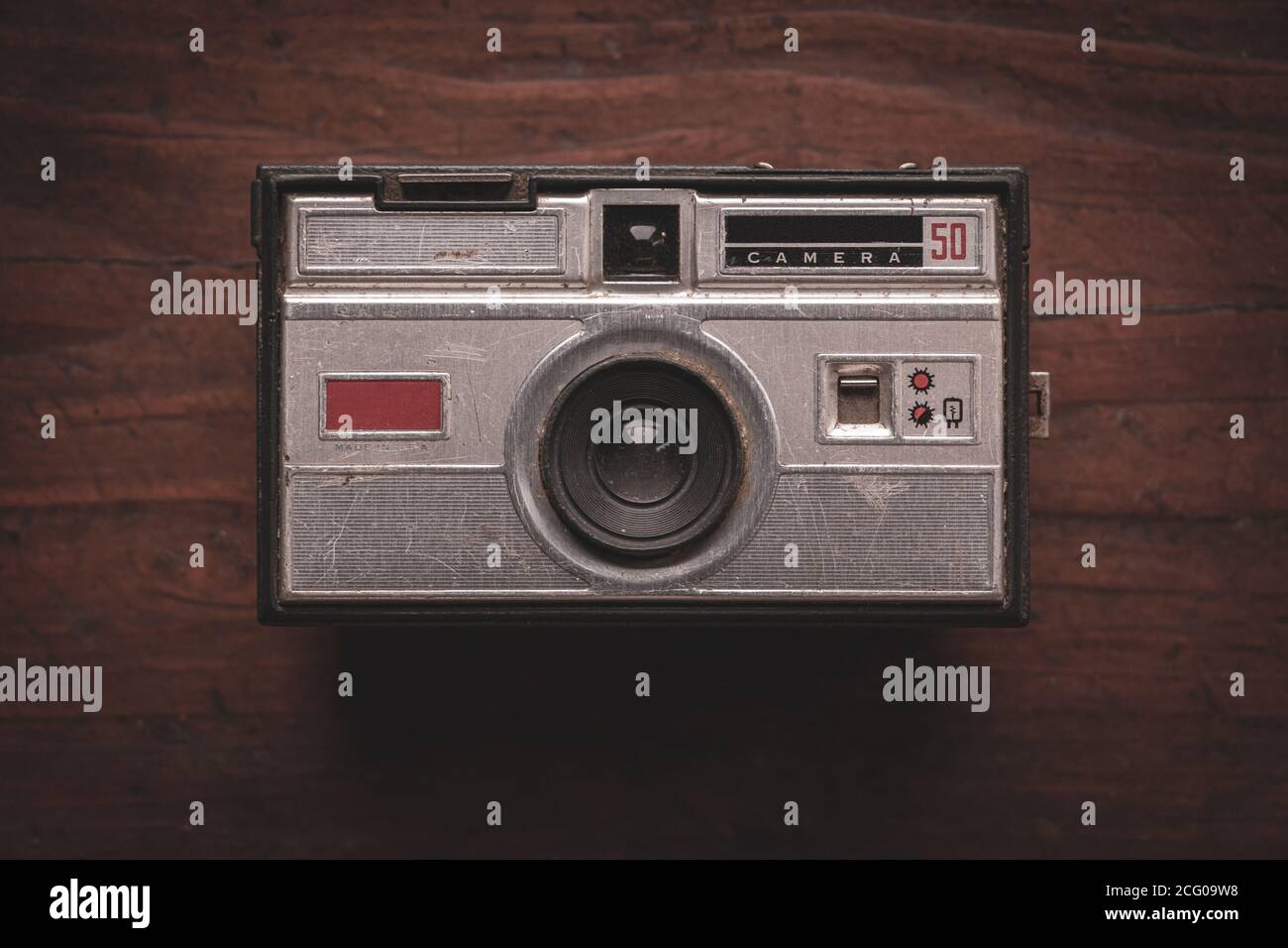 Old and worn photo camera from the 60s on rustic wooden table Stock ...