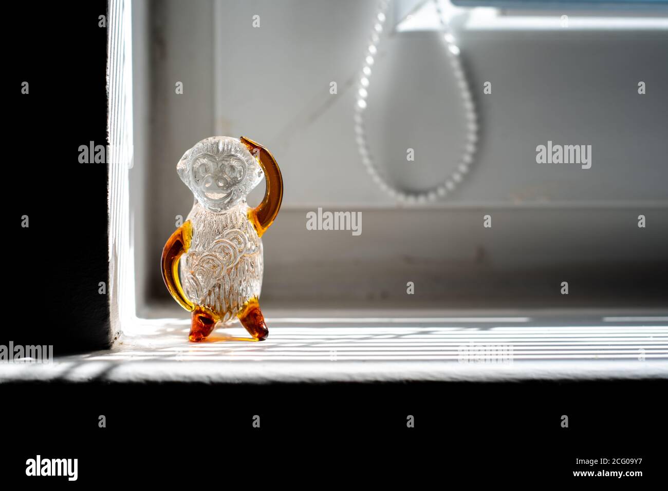 glass monkey figurine on the window Stock Photo - Alamy