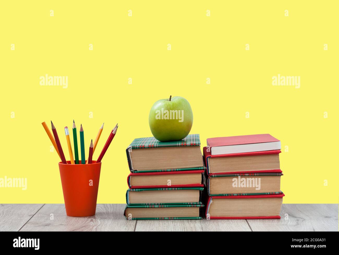 Books textbook in colorful covers on a yellow background. Back to ...