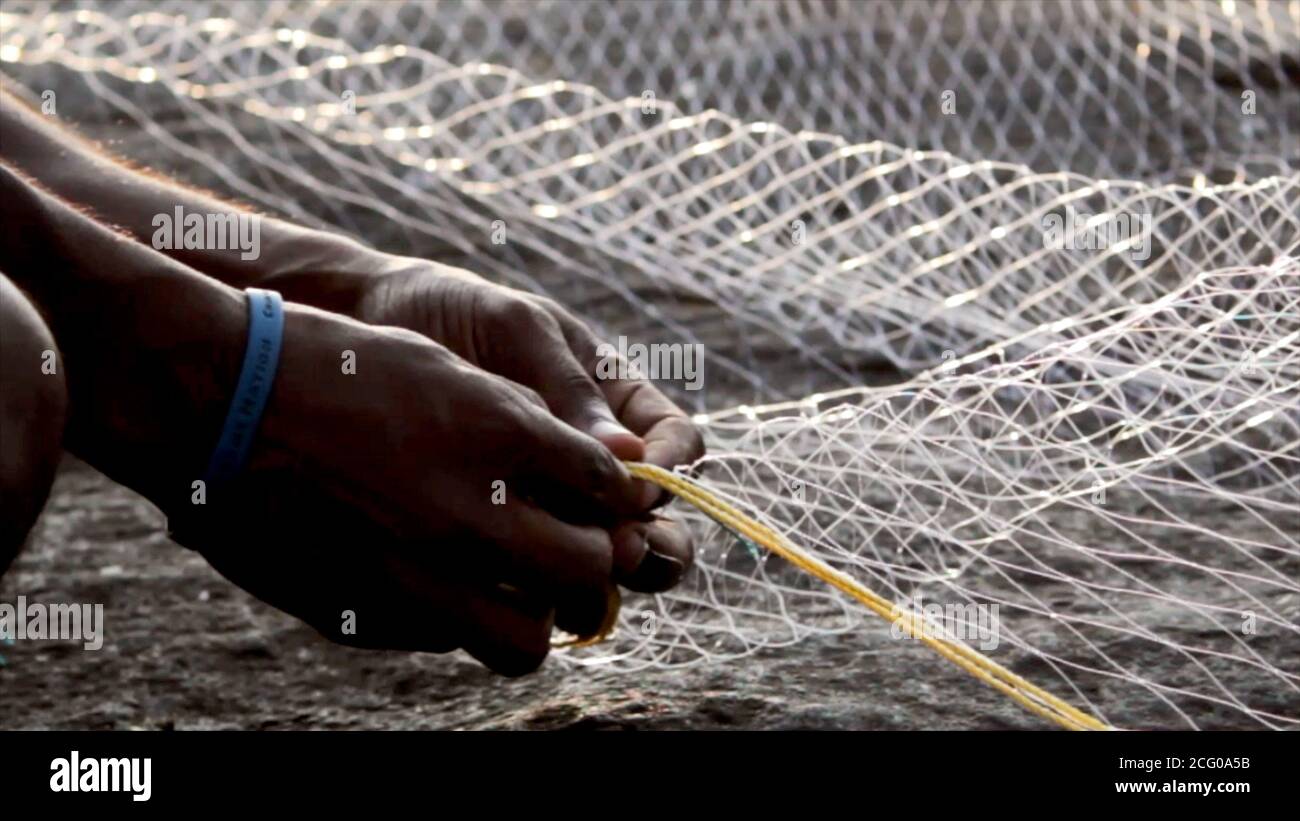 Indian man preparing the fishing net Stock Photo - Alamy