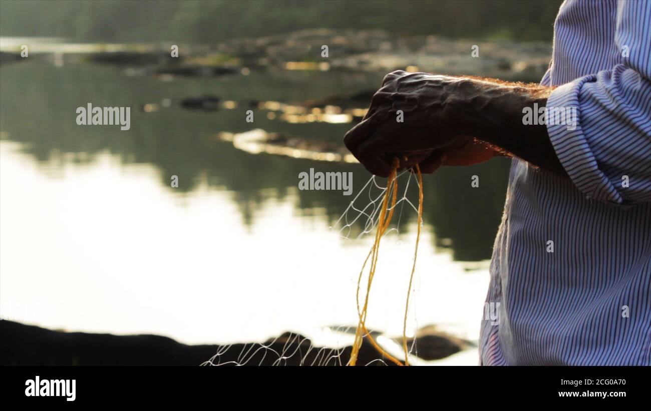 Indian man preparing the fishing net Stock Photo - Alamy