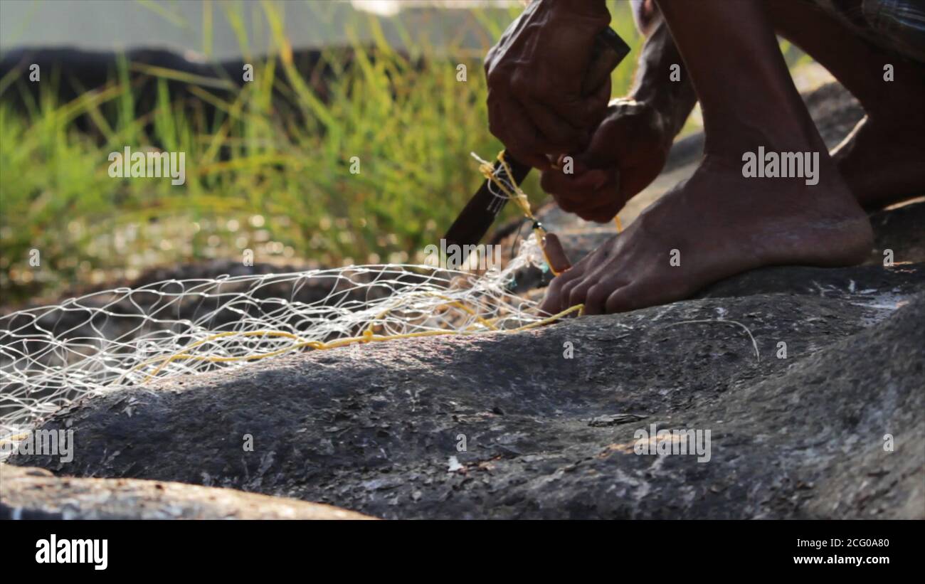 Indian man preparing the fishing net Stock Photo - Alamy