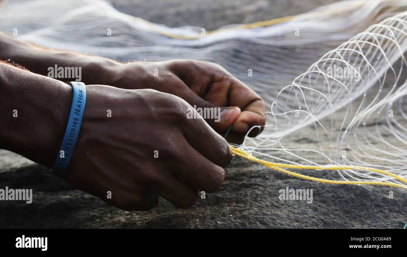 Indian man preparing the fishing net Stock Photo - Alamy