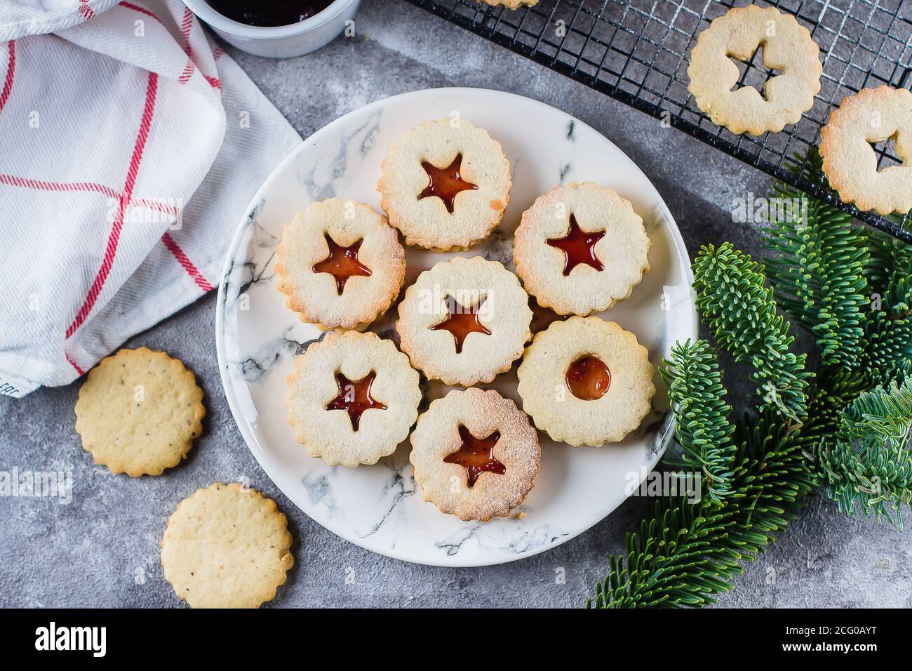 Christmas Linzer cookies with raspberry jam on concrete table ...