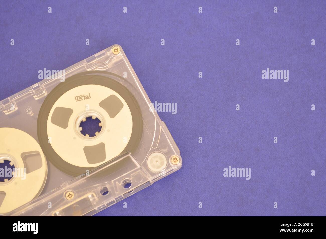 Metal cassette tape. Vintage metal audio cassette tape used to record music on blue background ...