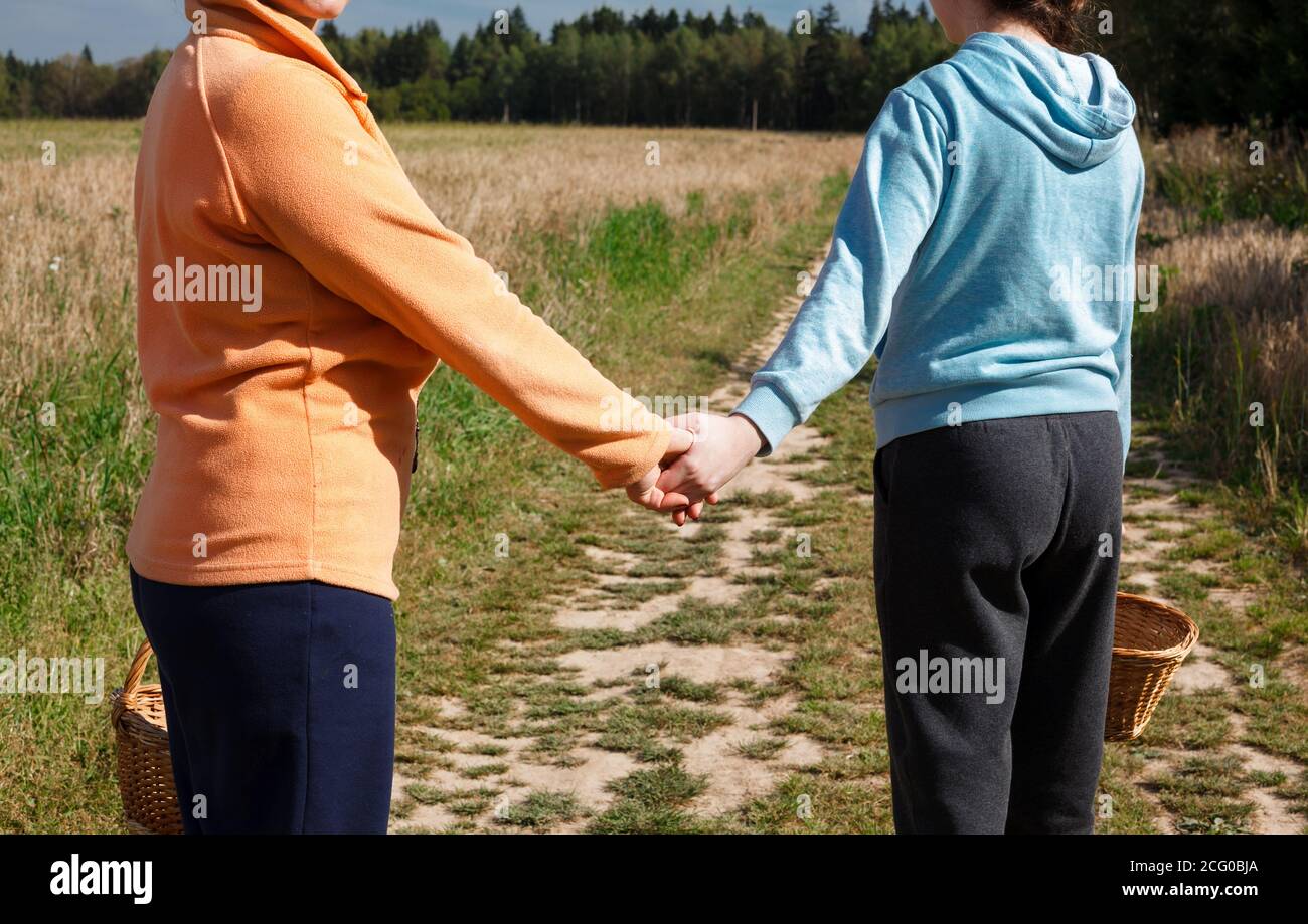 Family bonds concept. Mother and daughter hanging hands together ...