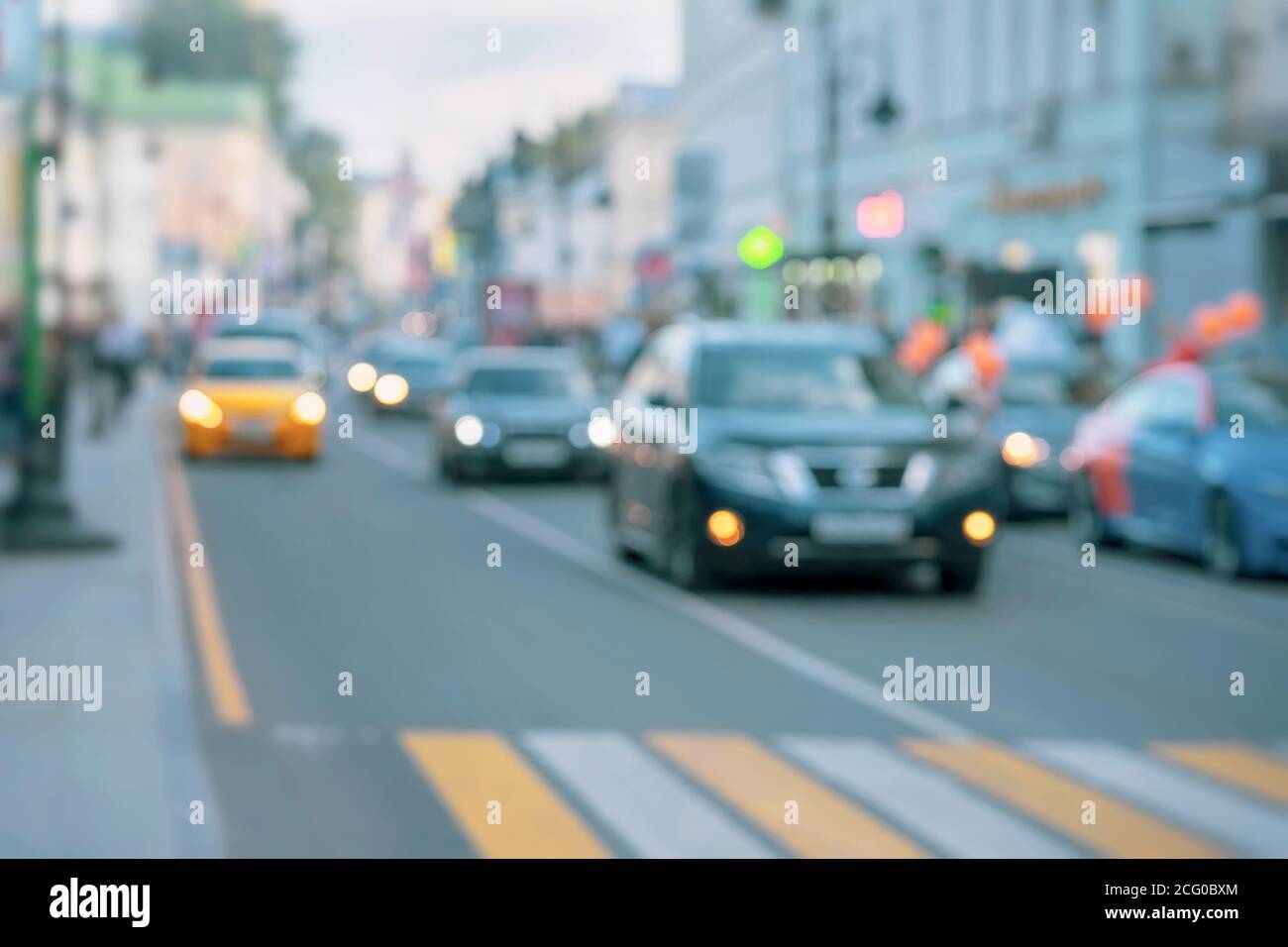 Abstract blurred background of moderate traffic in the city, stop at a ...
