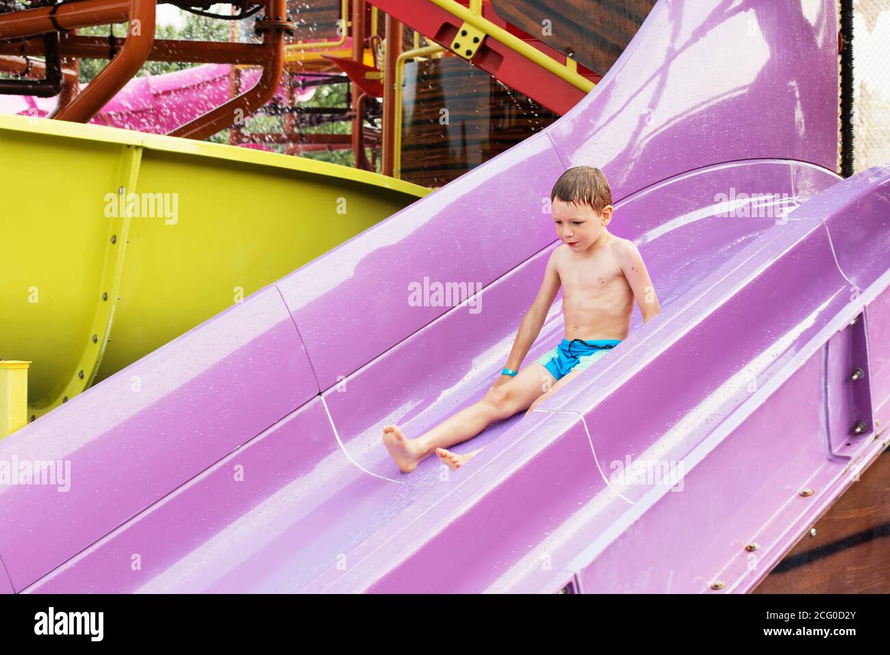 Happy boy going down slide hi-res stock photography and images - Alamy