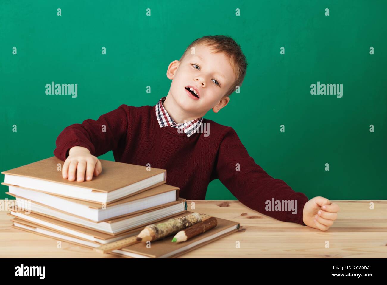 Young boy looking angry shaking his fists tired of school lessons ...