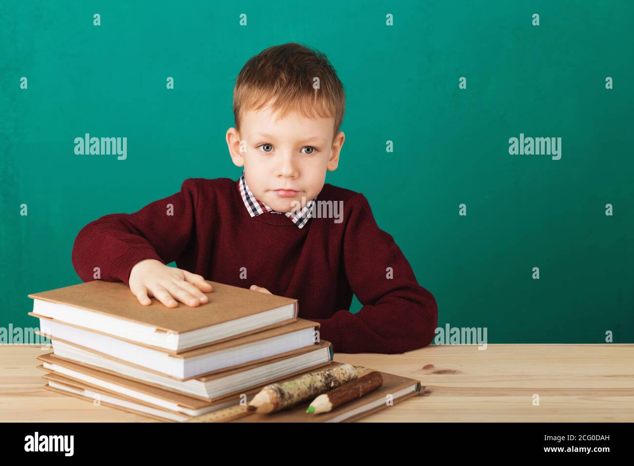 Young boy looking angry shaking his fists tired of school lessons ...