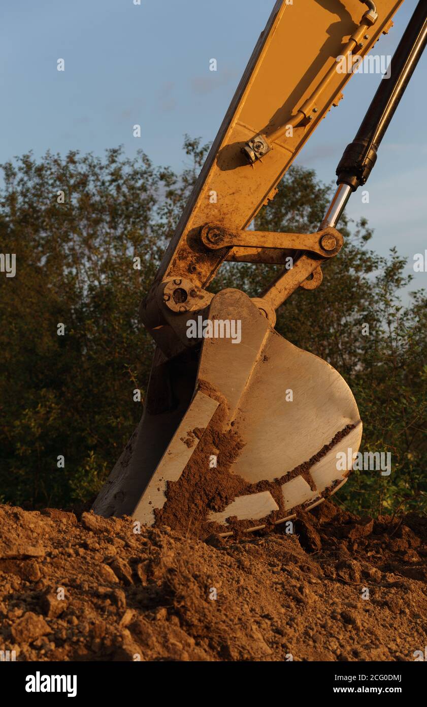 Side view of Excavator bucket on Construction site digging Stock Photo ...