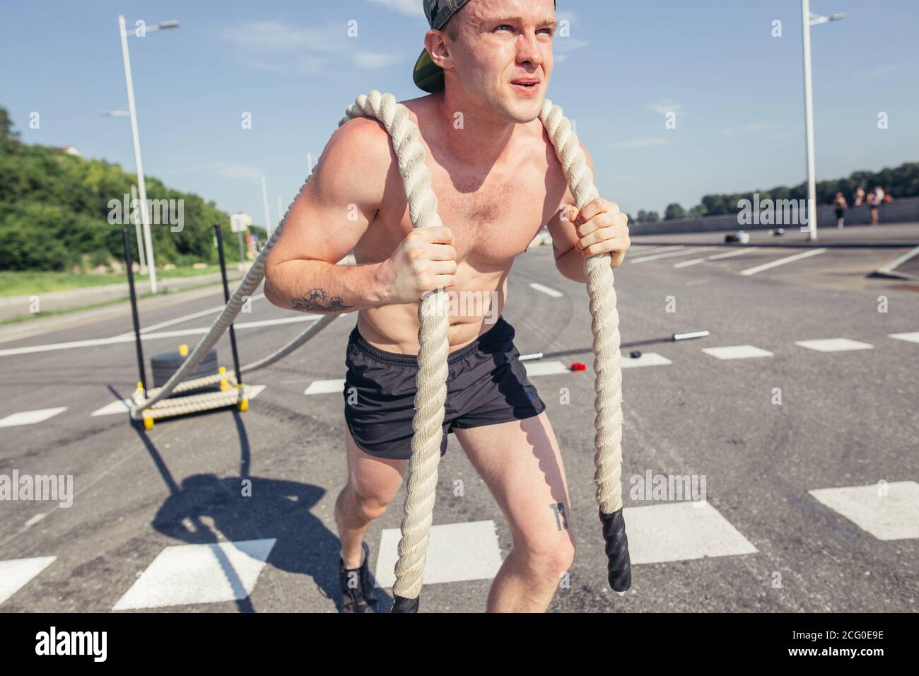 sled push man pushing weights workout exercise outdoor Stock Photo - Alamy