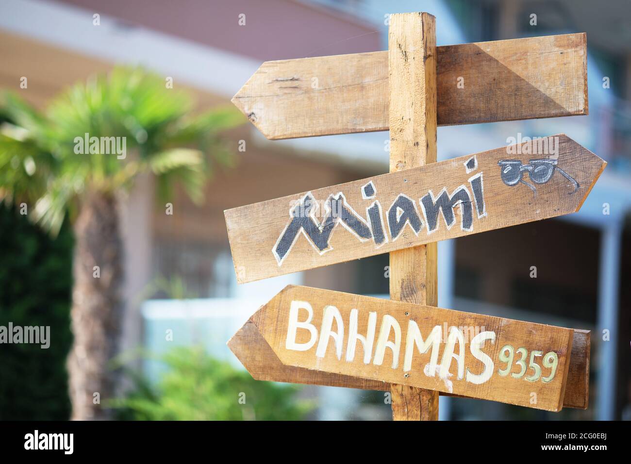 Wooden pointer post with copy space at the beach. arrows on a guidepost ...