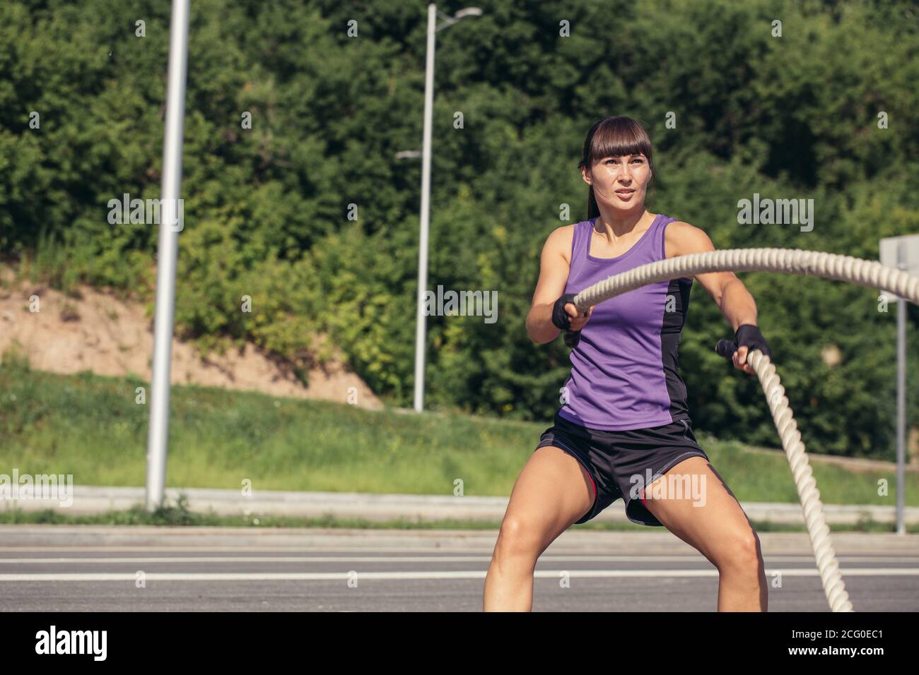 battling ropes woman outdoor workout exercise fitted body Stock Photo ...