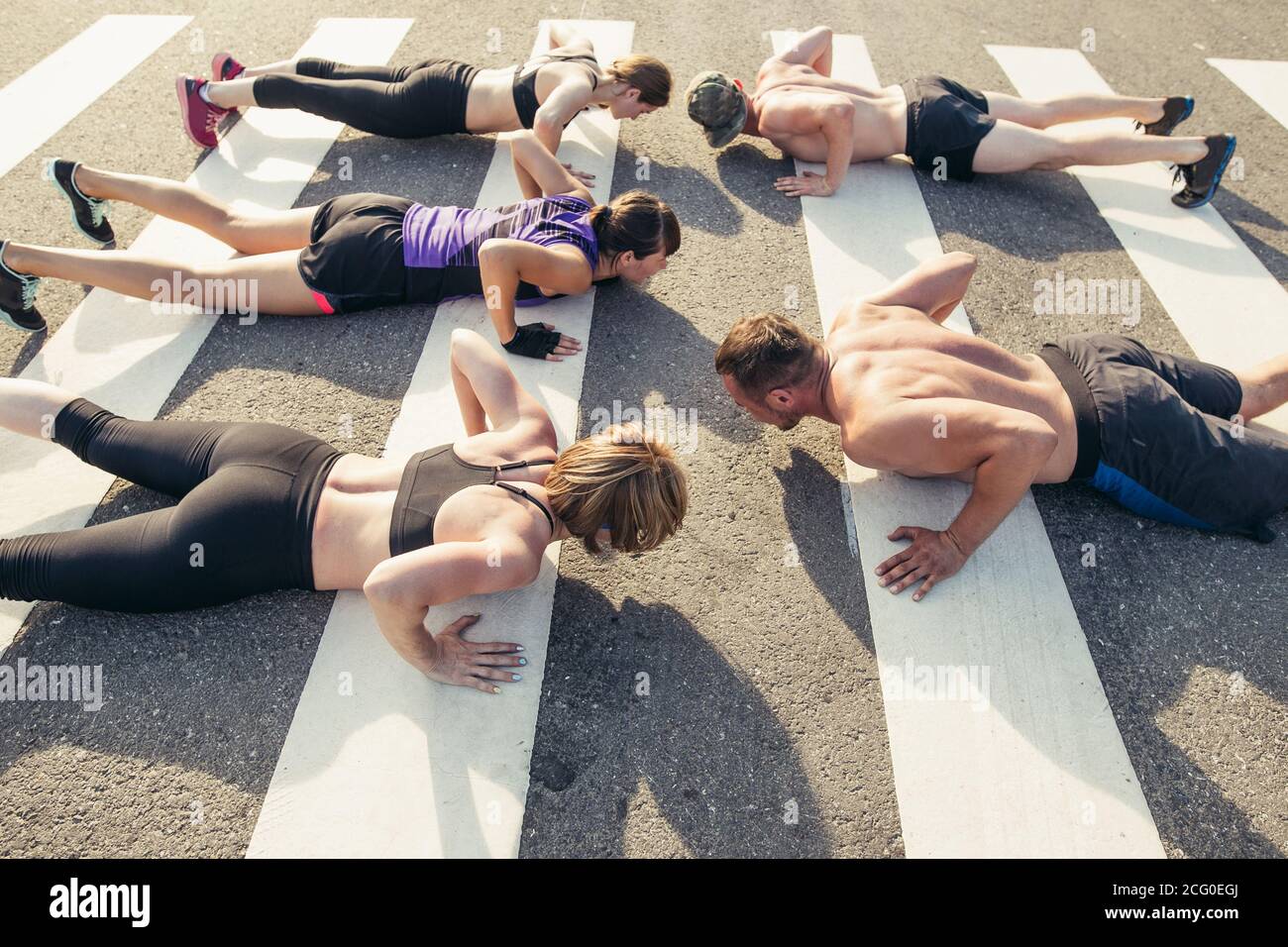 Fit young people focused on planking outdoor Stock Photo - Alamy