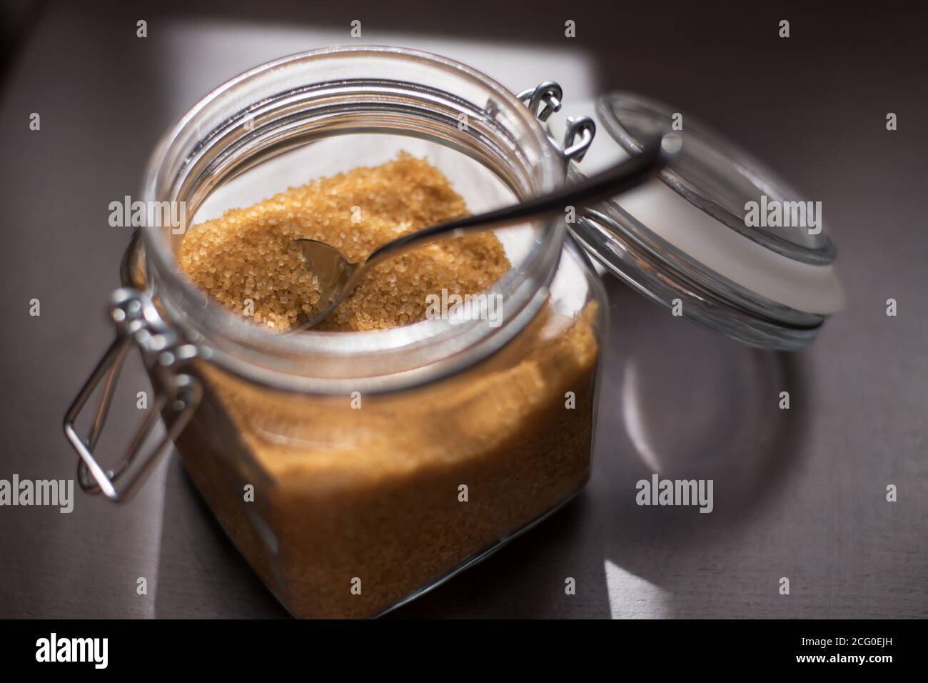 Transparent glass jar with brown sugar cane on a black background Stock ...