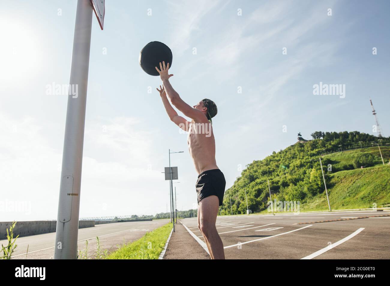 Workout bodyweight exercises using heavy weight ball Stock Photo - Alamy