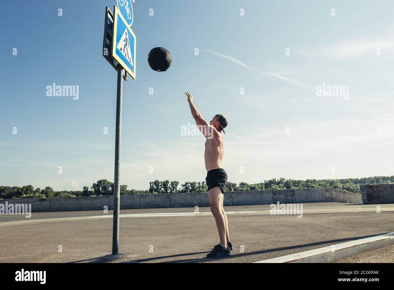 Workout bodyweight exercises using heavy weight ball Stock Photo - Alamy