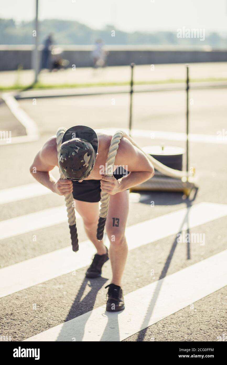 Sled push man pushing weights hi-res stock photography and images - Alamy