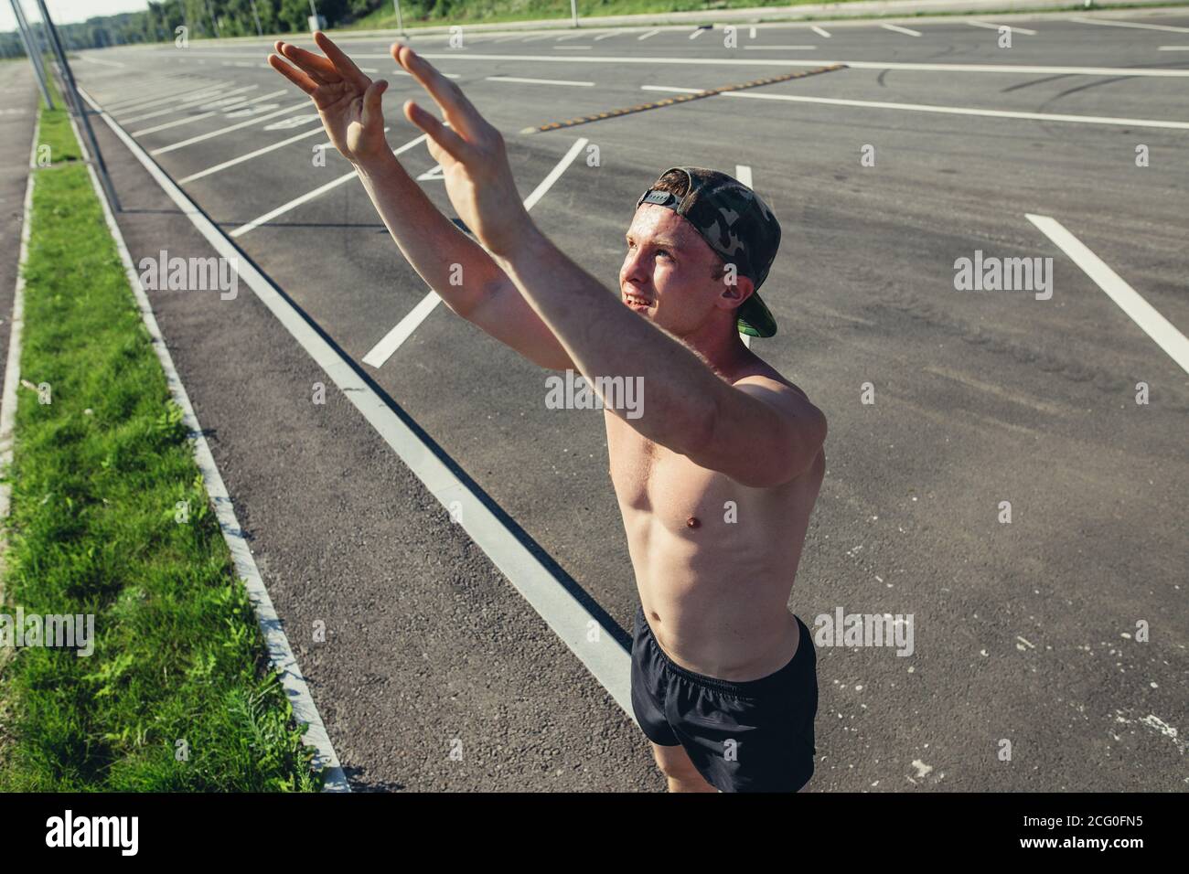 Strength training fit man cross training throwing medicine ball on gym ...