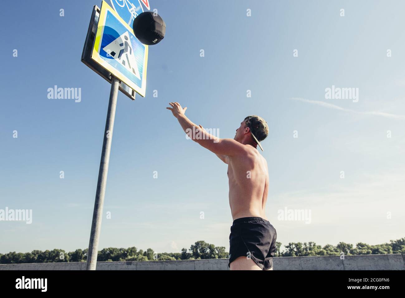 Workout bodyweight exercises using heavy weight ball Stock Photo - Alamy