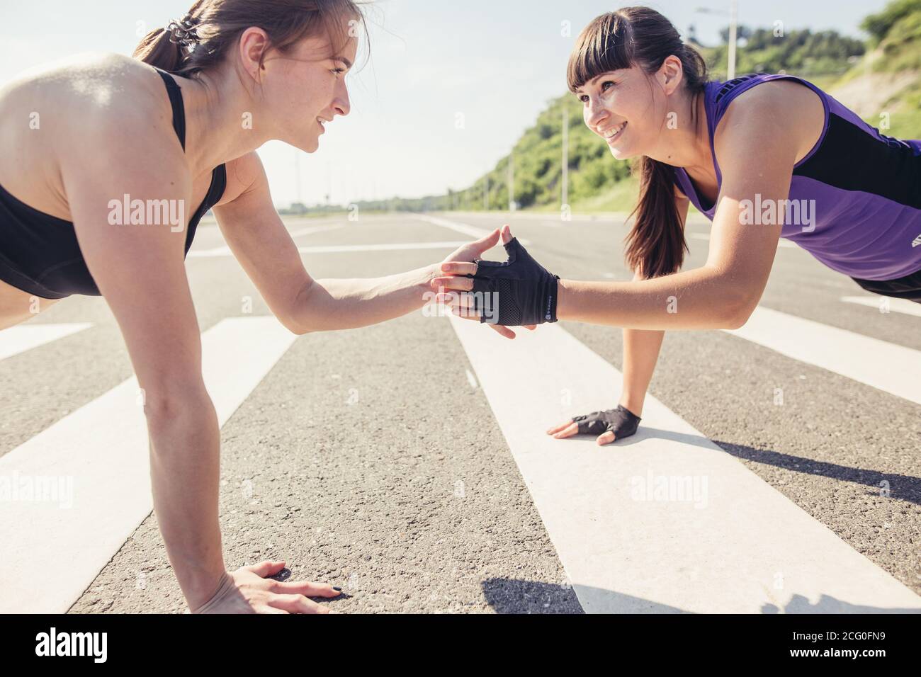 Side view of a group of fitness people doing push ups Stock Photo - Alamy