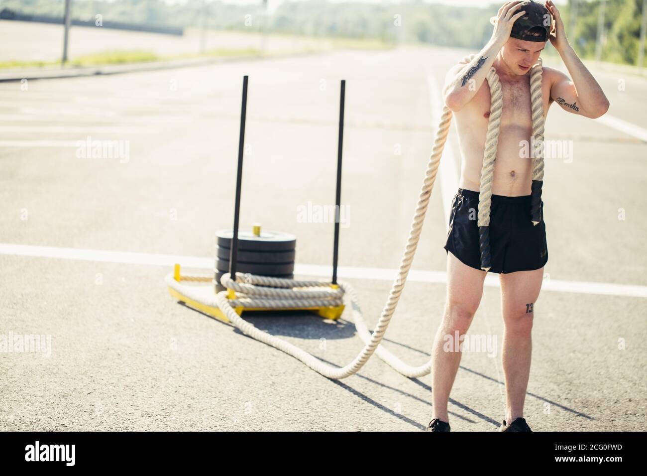 sled push man pushing weights workout exercise outdoor Stock Photo - Alamy