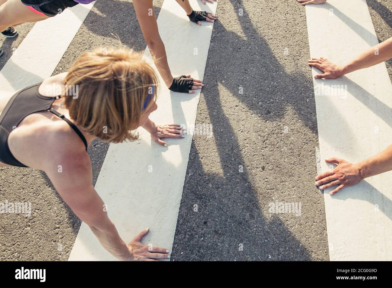 Fit young people focused on planking outdoor Stock Photo - Alamy