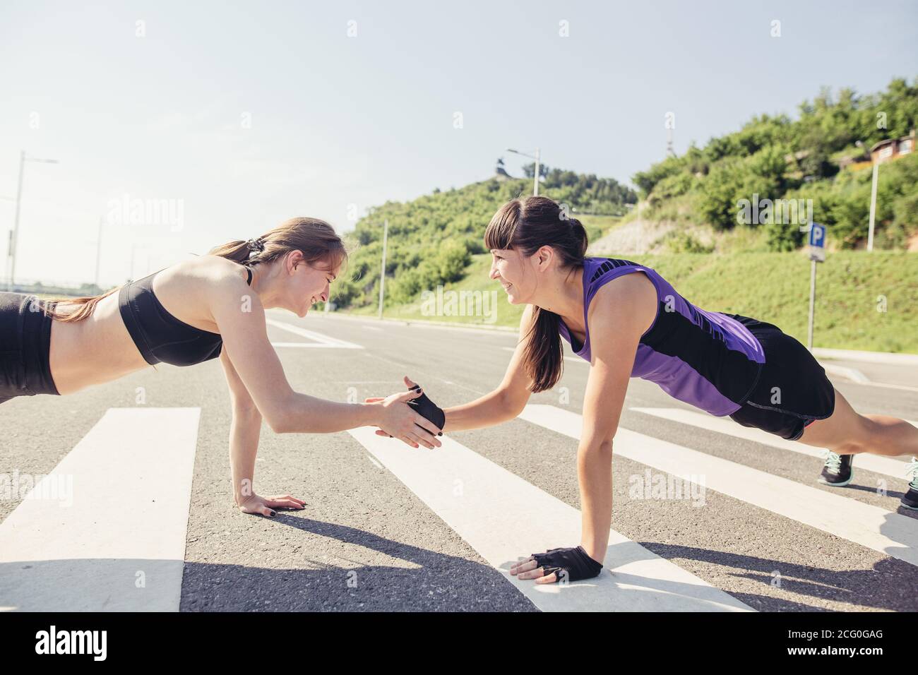 Group of adults performing push up exercise drills at outdoor physical ...