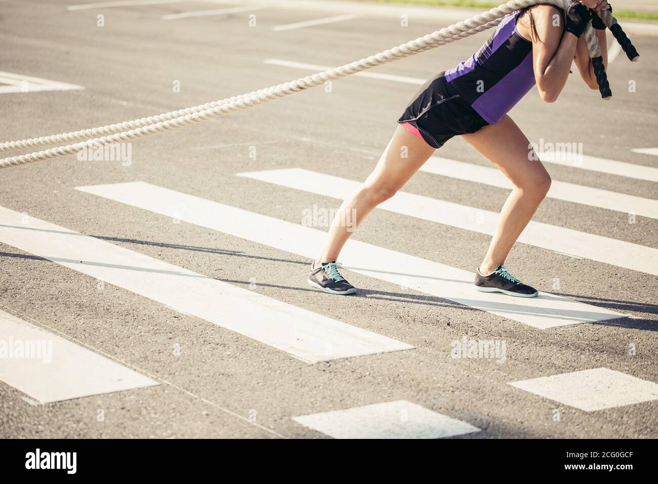 Woman Pulling Cross fit Sled on asphalt Stock Photo - Alamy