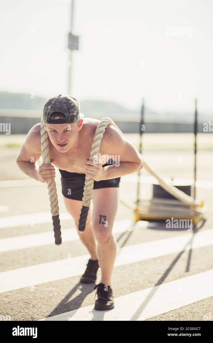 sled push man pushing weights workout exercise outdoor Stock Photo - Alamy