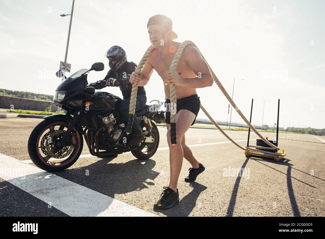 sled push man pushing weights workout and competing with motorcycle ...