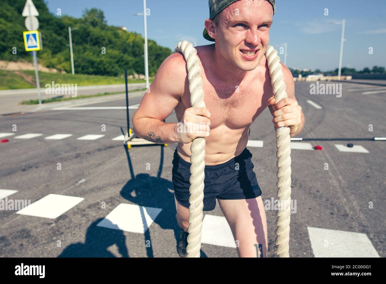 sled push man pushing weights workout exercise outdoor Stock Photo - Alamy