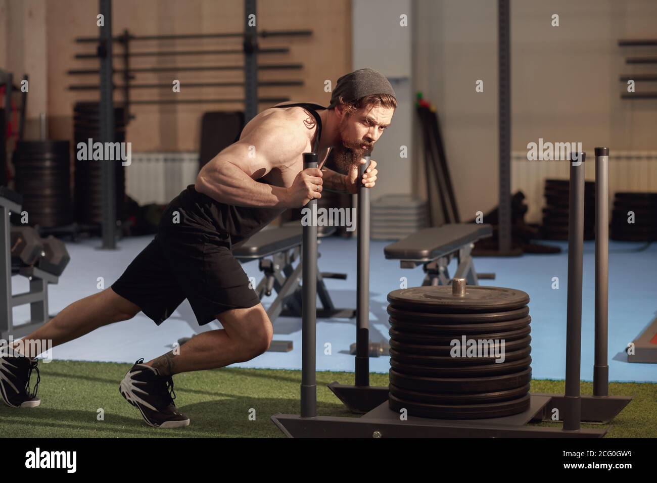 Sled push man pushing weights hi-res stock photography and images - Alamy
