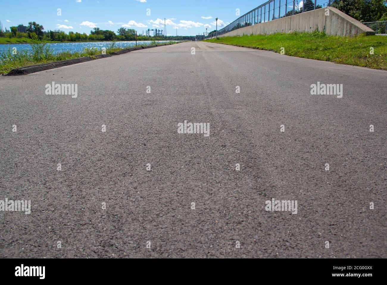 Road next to a canal Stock Photo - Alamy