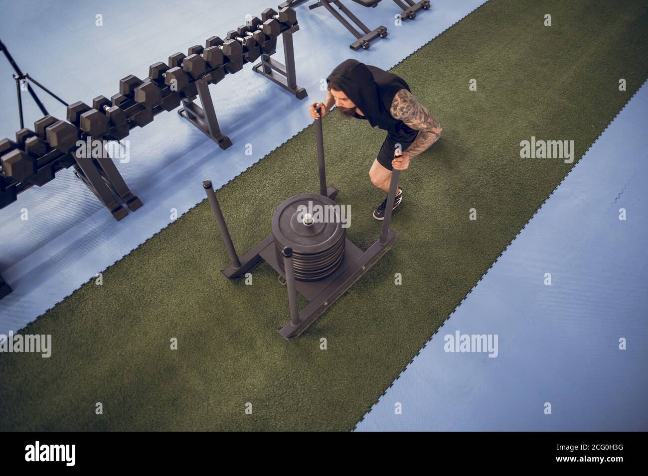 Sled push man pushing weights hi-res stock photography and images - Alamy