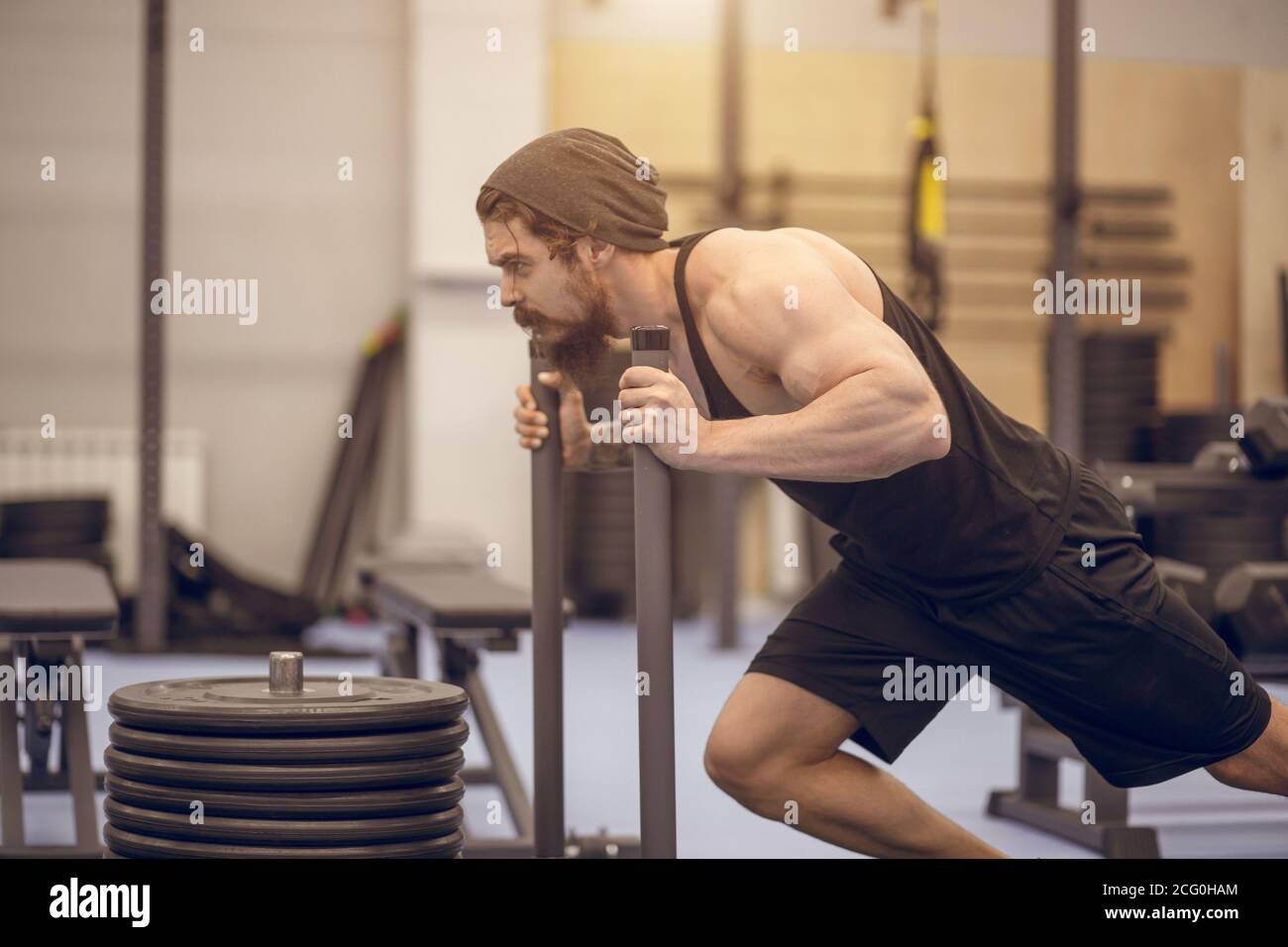 Sled push man pushing weights hi-res stock photography and images - Alamy
