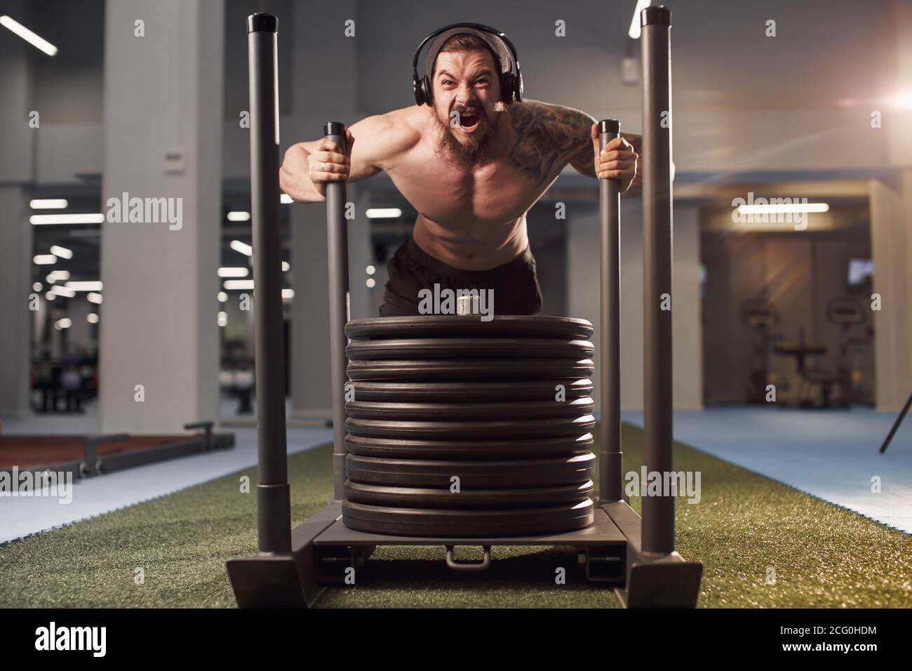 Sled push man pushing weights hi-res stock photography and images - Alamy