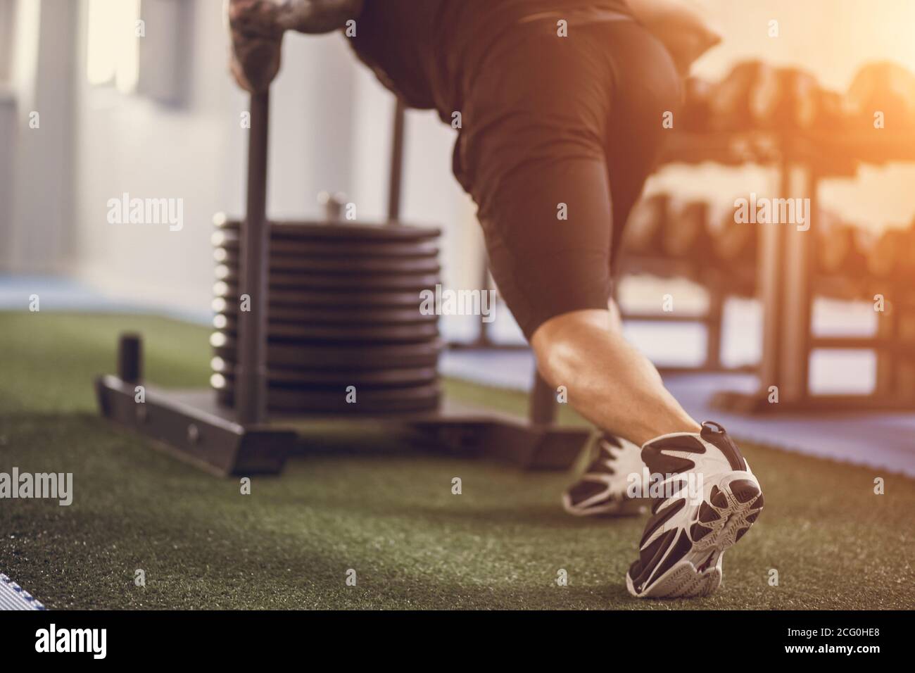 Sled push man pushing weights hi-res stock photography and images - Alamy