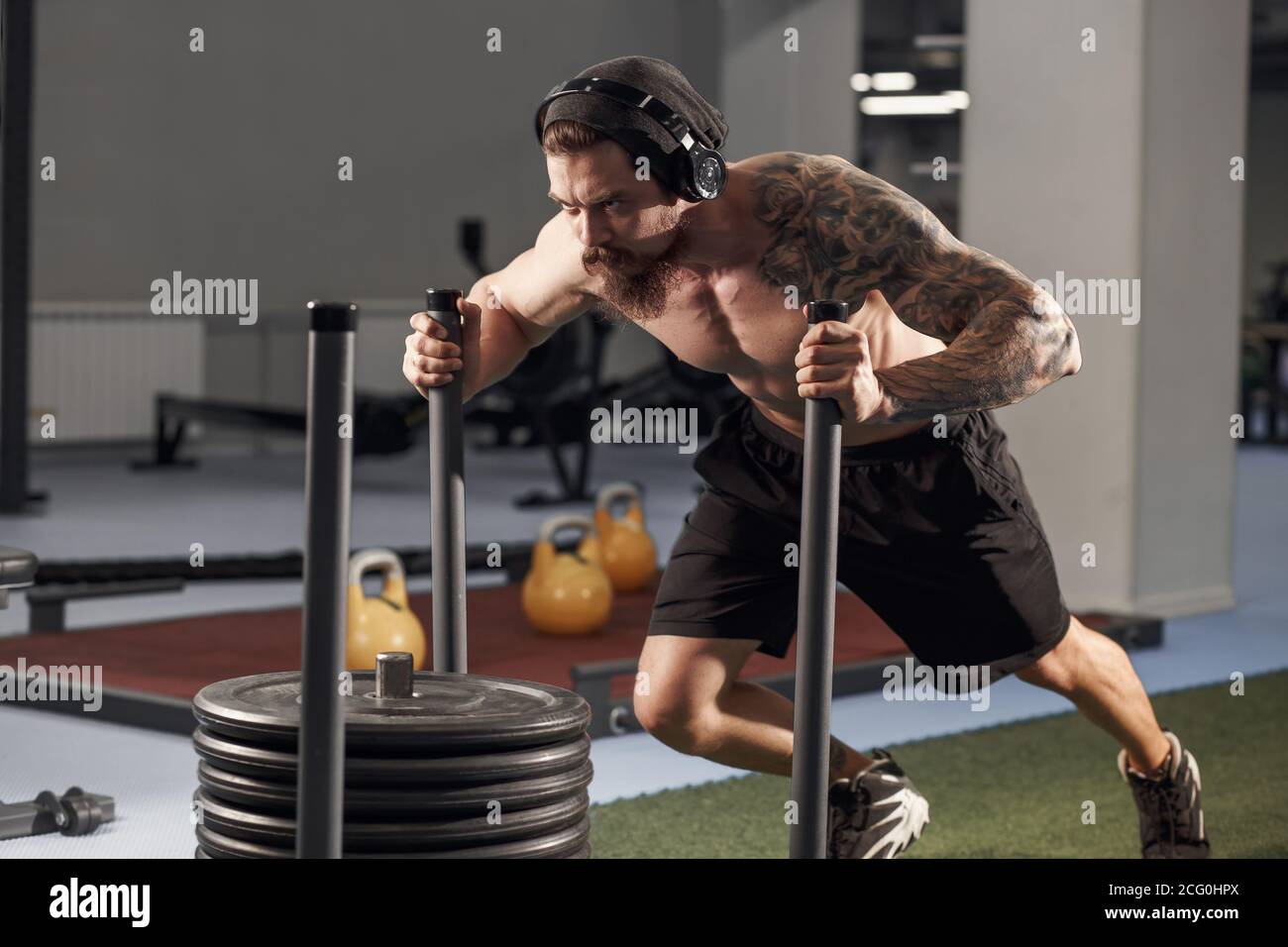 sled push man pushing weights workout exercise at gym Stock Photo - Alamy
