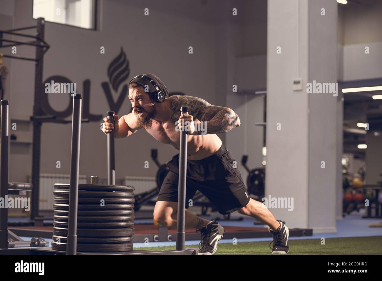 sled push man pushing weights workout exercise at gym Stock Photo - Alamy