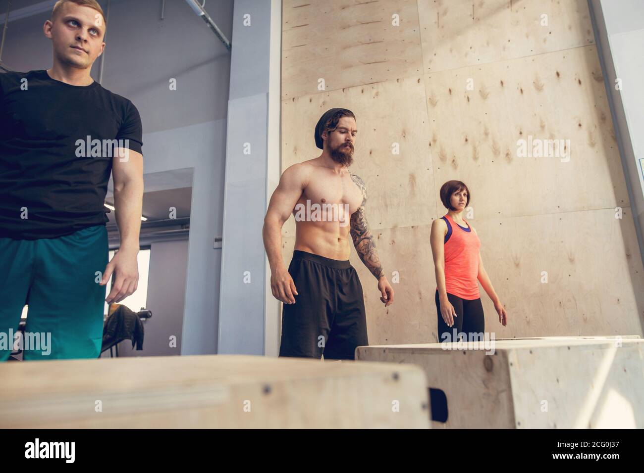 Male and female athletes doing box jumps at gym Stock Photo - Alamy
