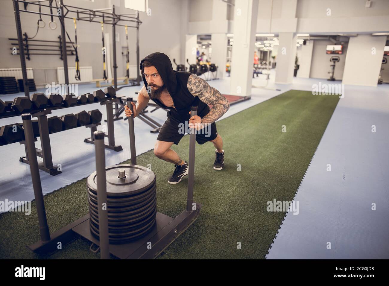 Sled push man pushing weights hi-res stock photography and images - Alamy