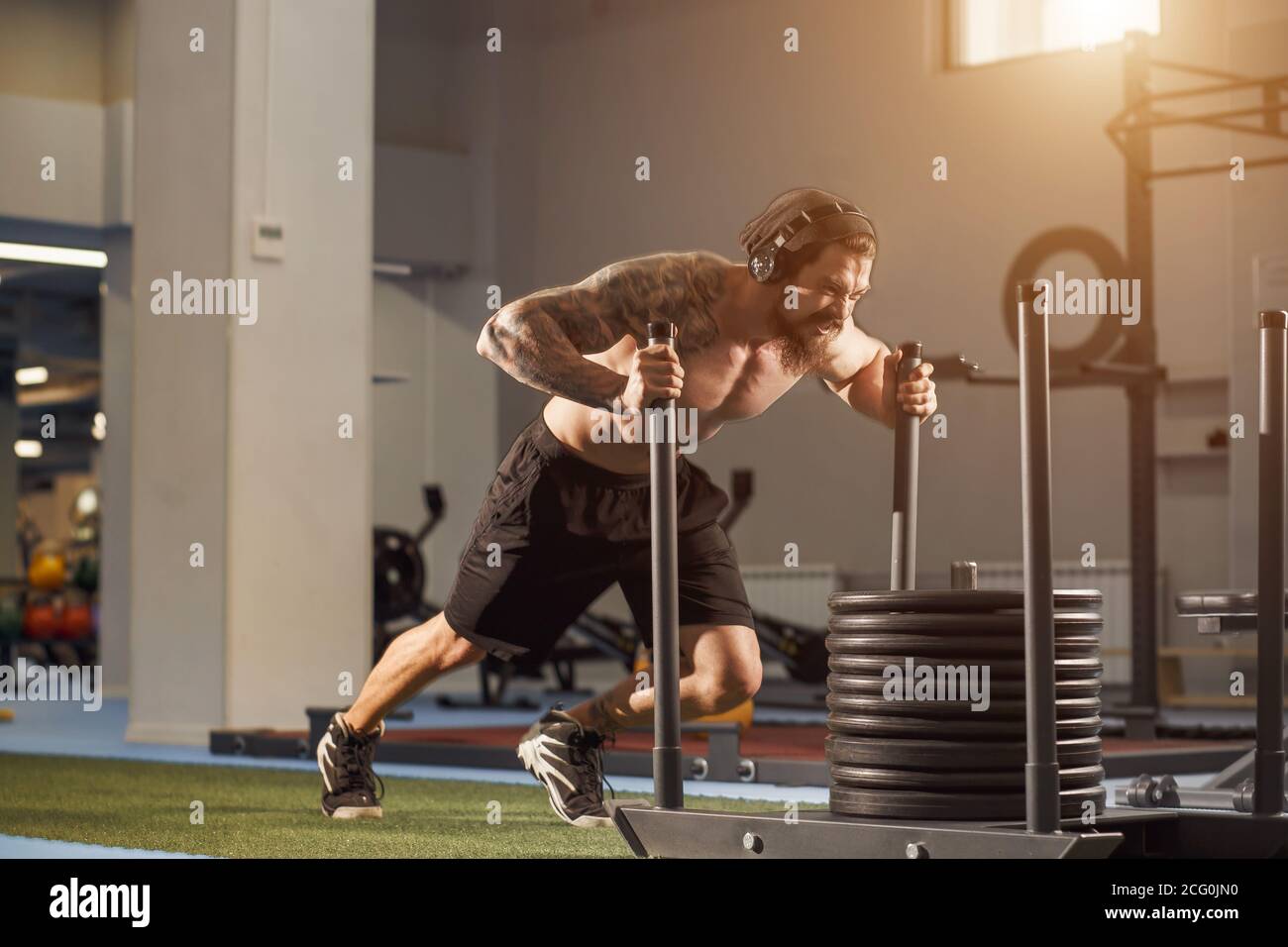 Sled push man pushing weights hi-res stock photography and images - Alamy